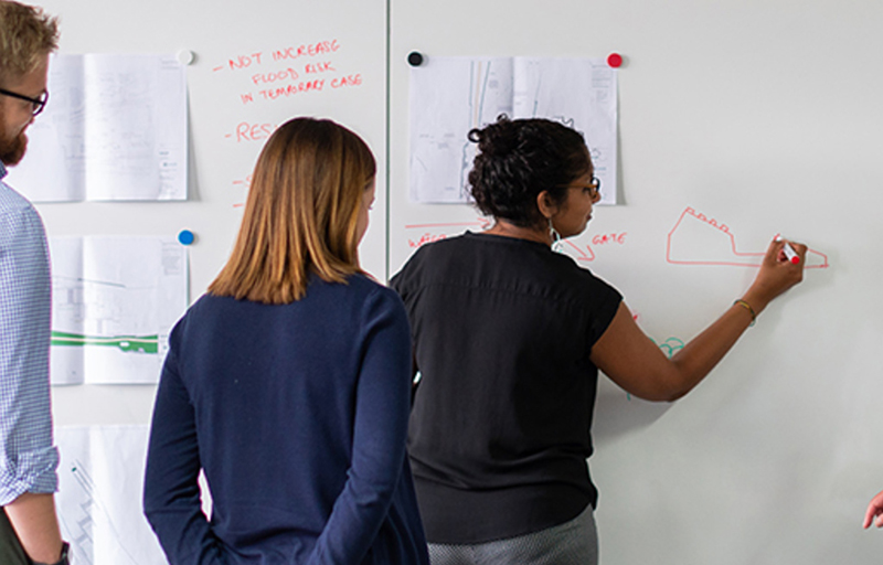 Students working on a whiteboard.